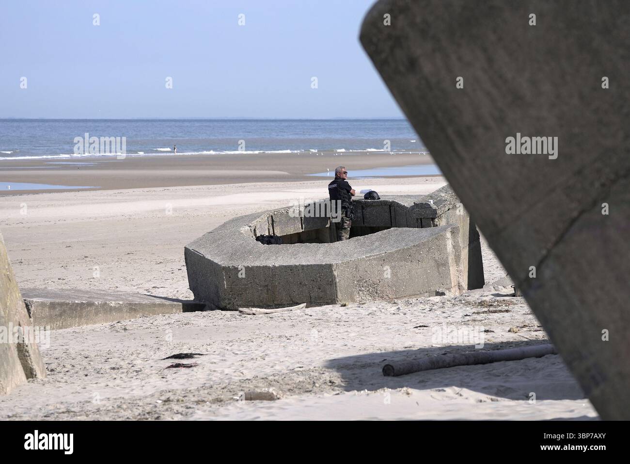 A gendarme stands in a WWII nazi bunker at Ecault beach, Friday July 4 ...