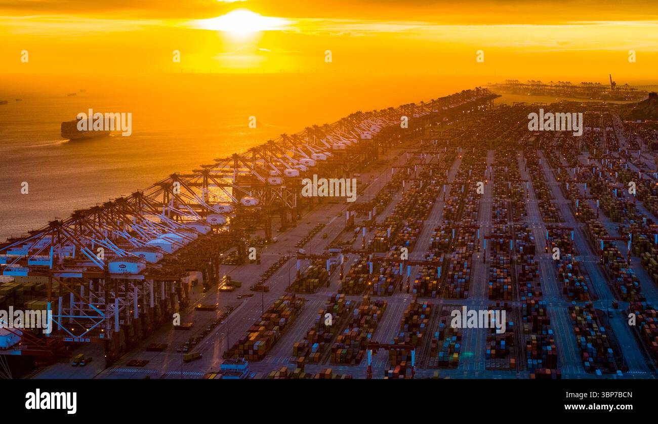 A cargo ship is loading and unloading at the container terminal of ...