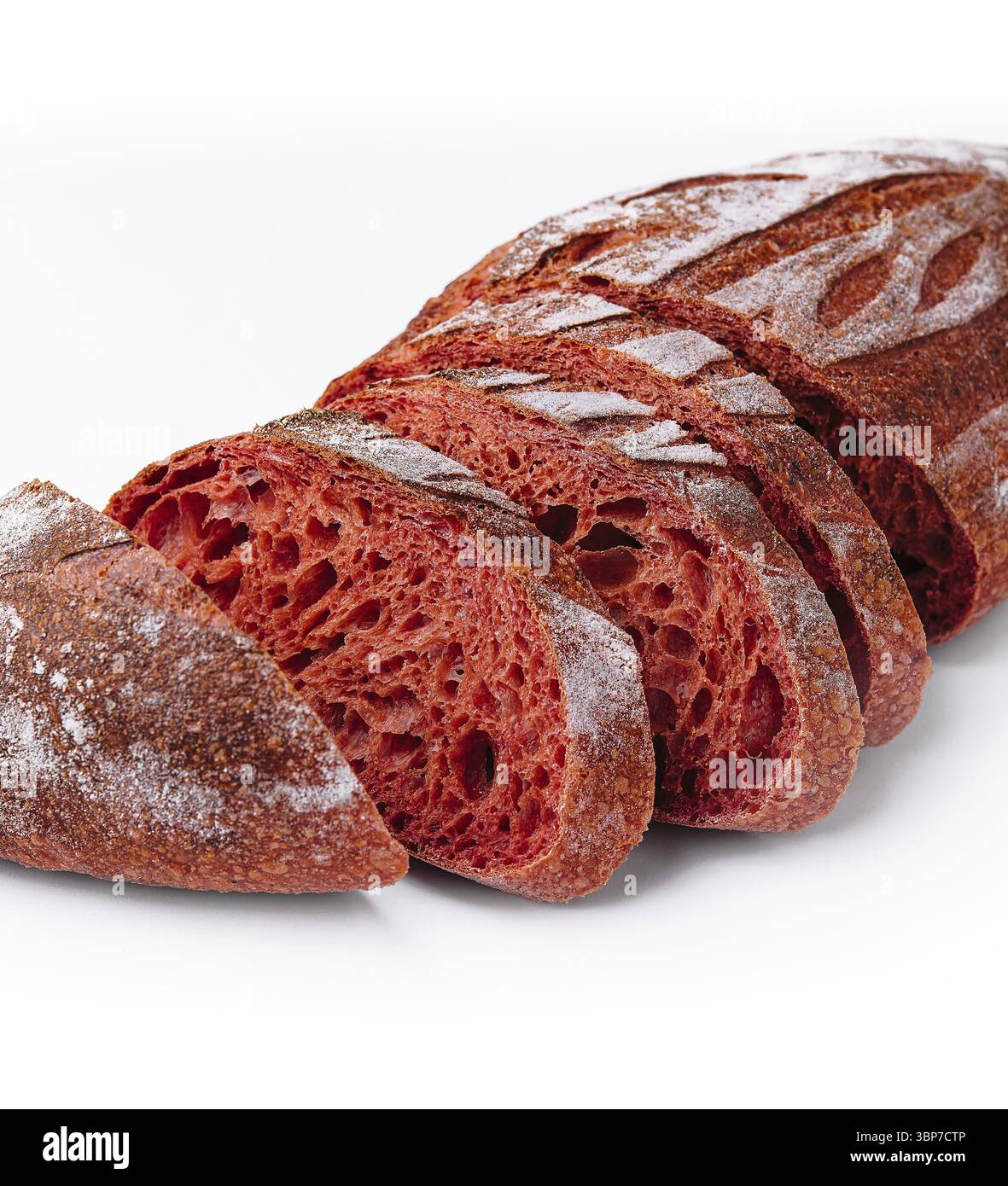 Food, Vibrant sliced loaf of beetroot bread isolated on a white background, showcasing its ...