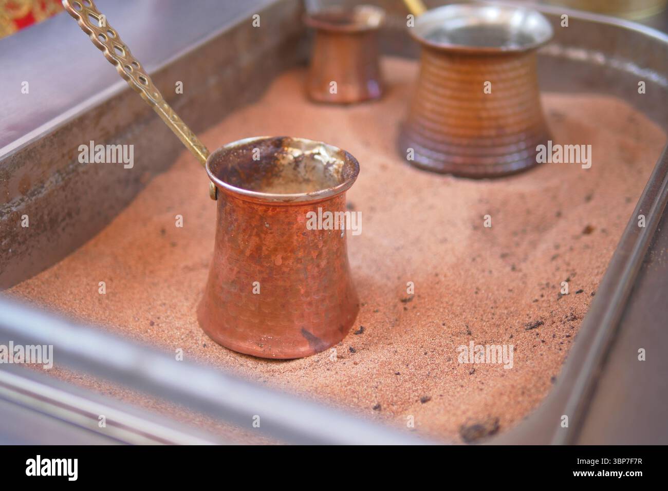 turkish Coffee preparation in a traditional sand container Stock Photo ...