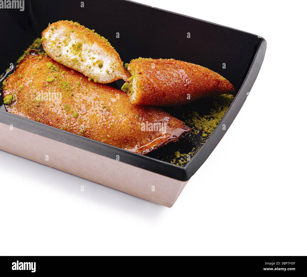 Food, Two syrup-soaked pastries are served in a black container. The ...