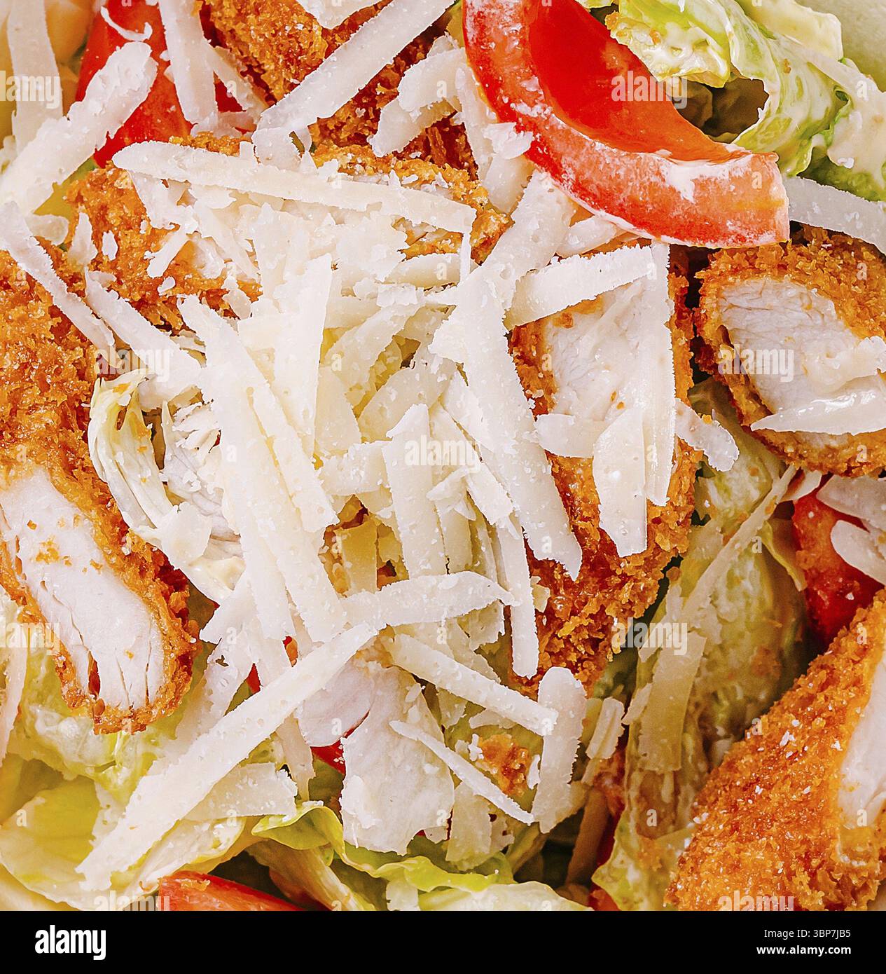 Food, A hearty salad featuring crispy chicken strips atop a bed of ...
