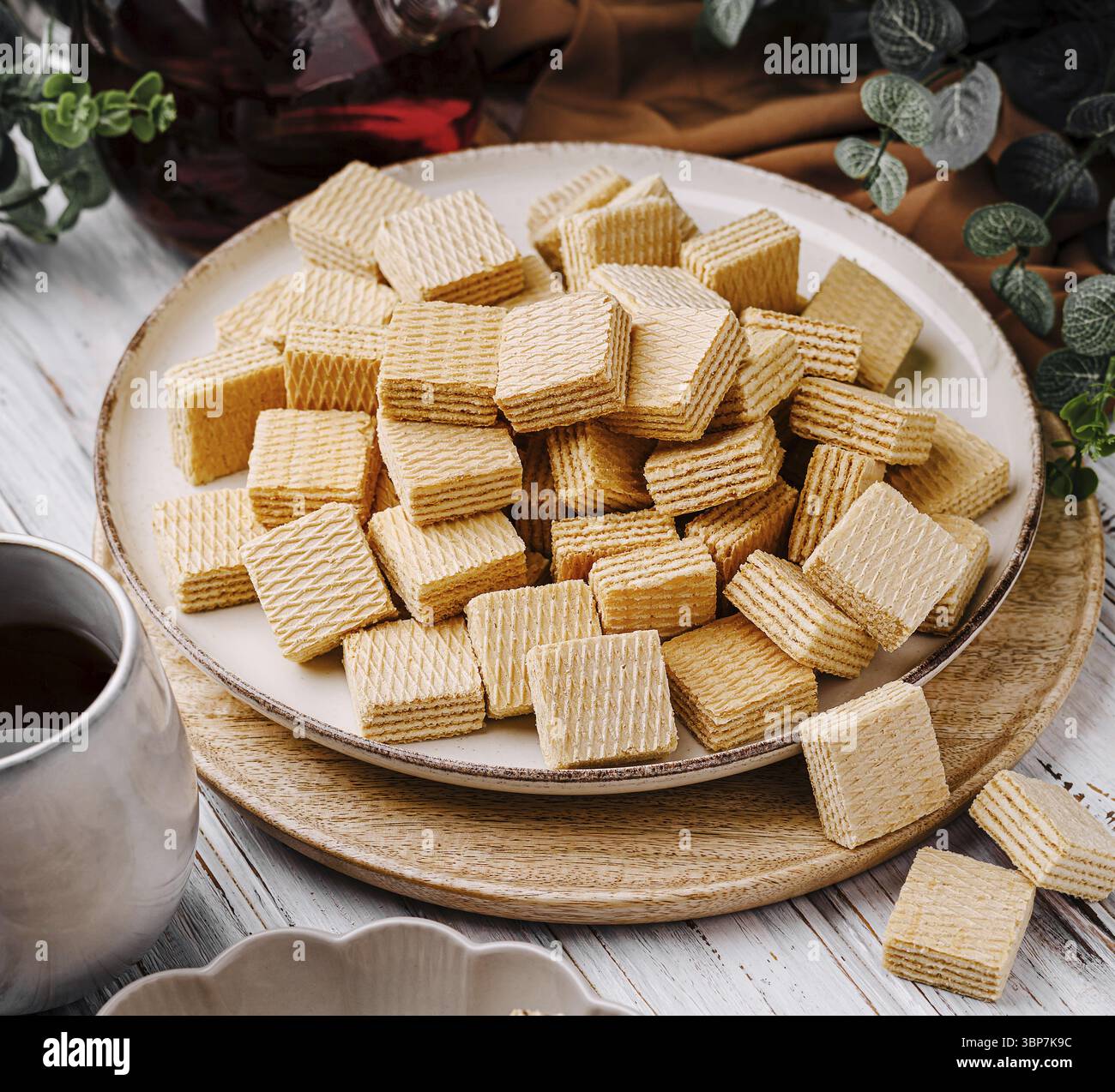 Food, A platter filled with golden wafer cookies is displayed alongside ...