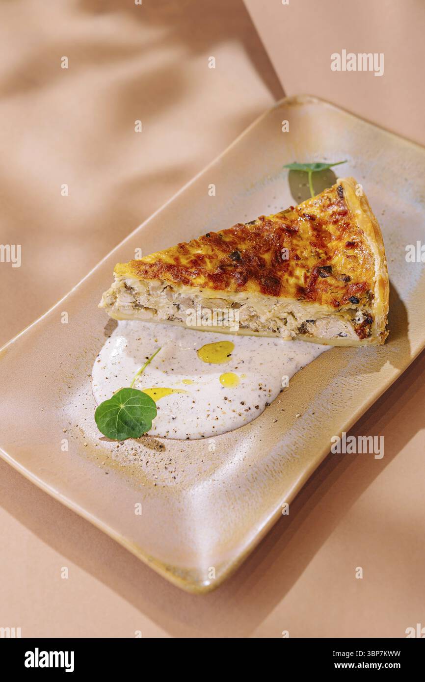 Food, Stylish presentation of a classic quiche slice with sauce and ...