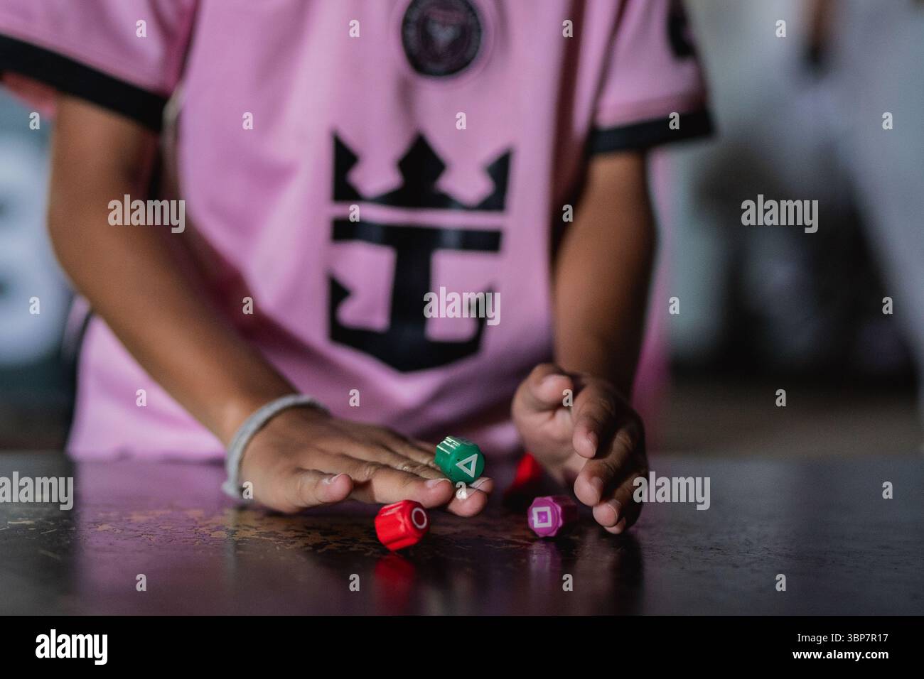 A child plays Gonggi, a traditional Korean children's game. On the ...