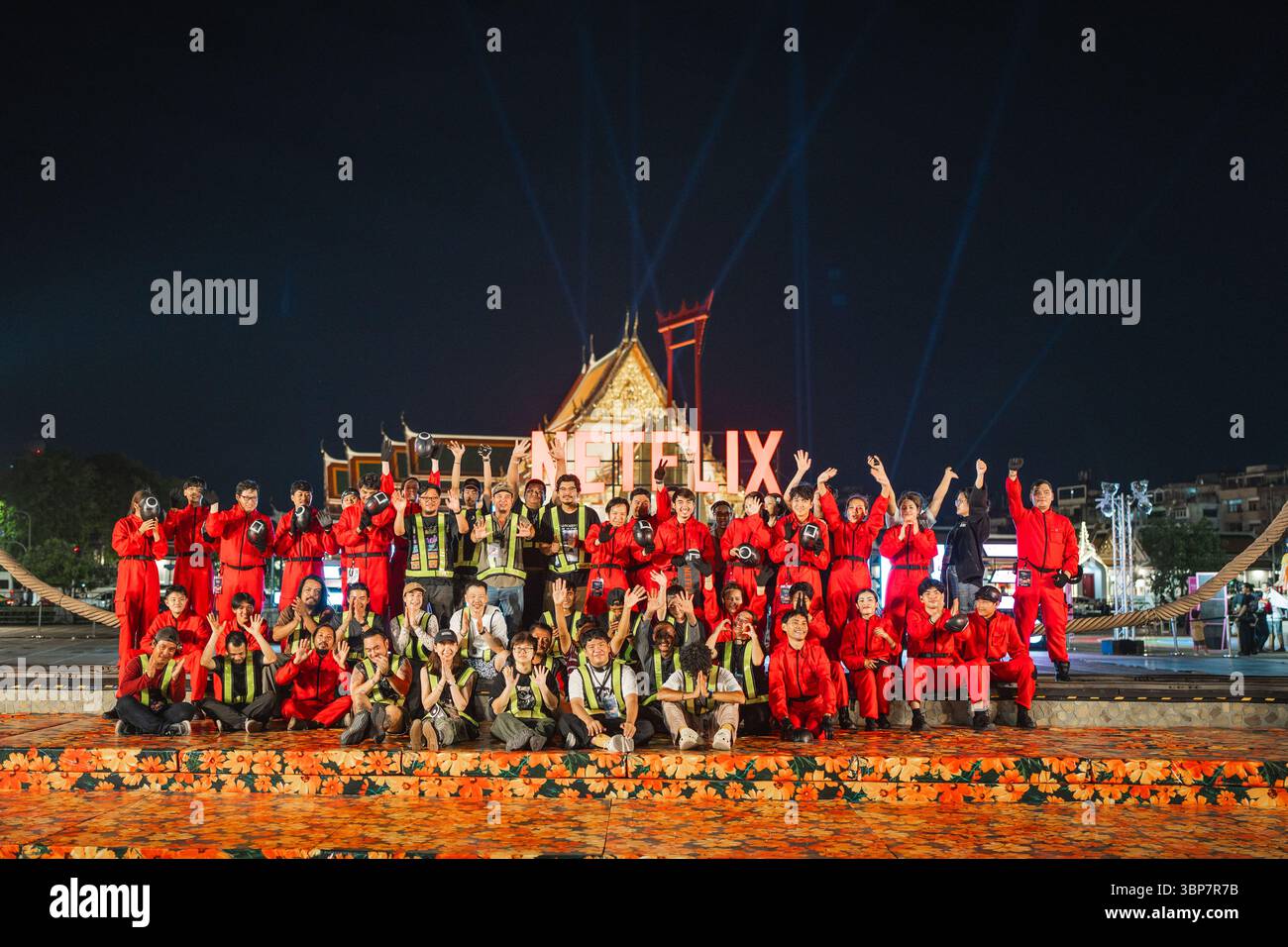 Members of the technical and organizing team, including performers dressed as red mask guards ...