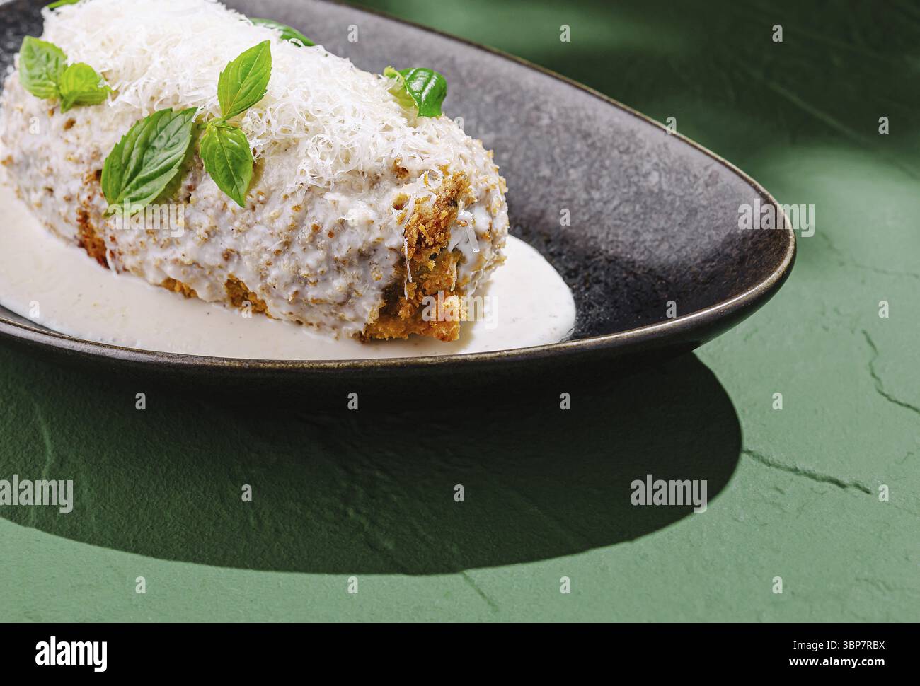 Food, A unique dessert presented on a black plate showcases a creamy ...