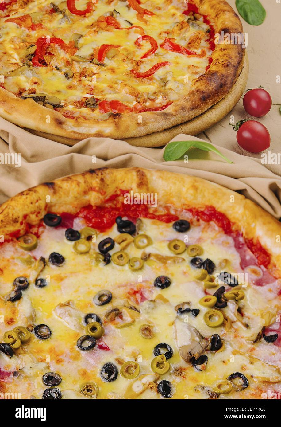 Food, Two delicious pizzas with savory toppings on a beige background ...