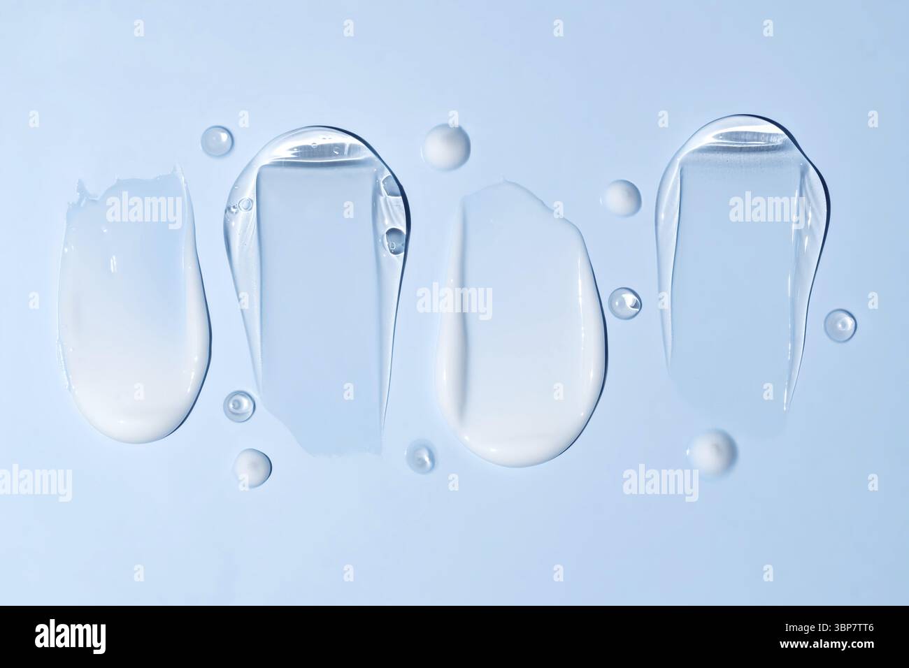 Liquid cream and gel cosmetic smudge drops texture on blue background ...
