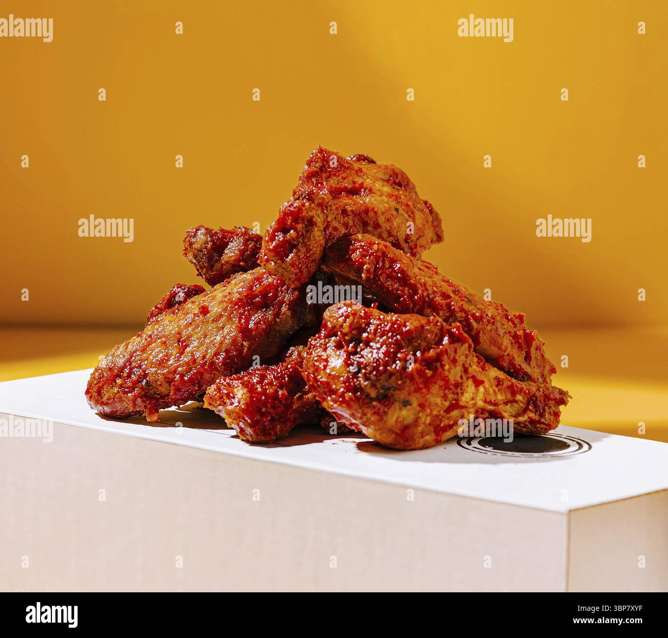 Food, A generous stack of spicy chicken wings is displayed atop a ...