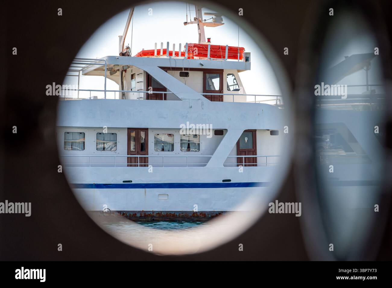 A boat is docked in the harbor of Crete, Greece, viewed through a ...