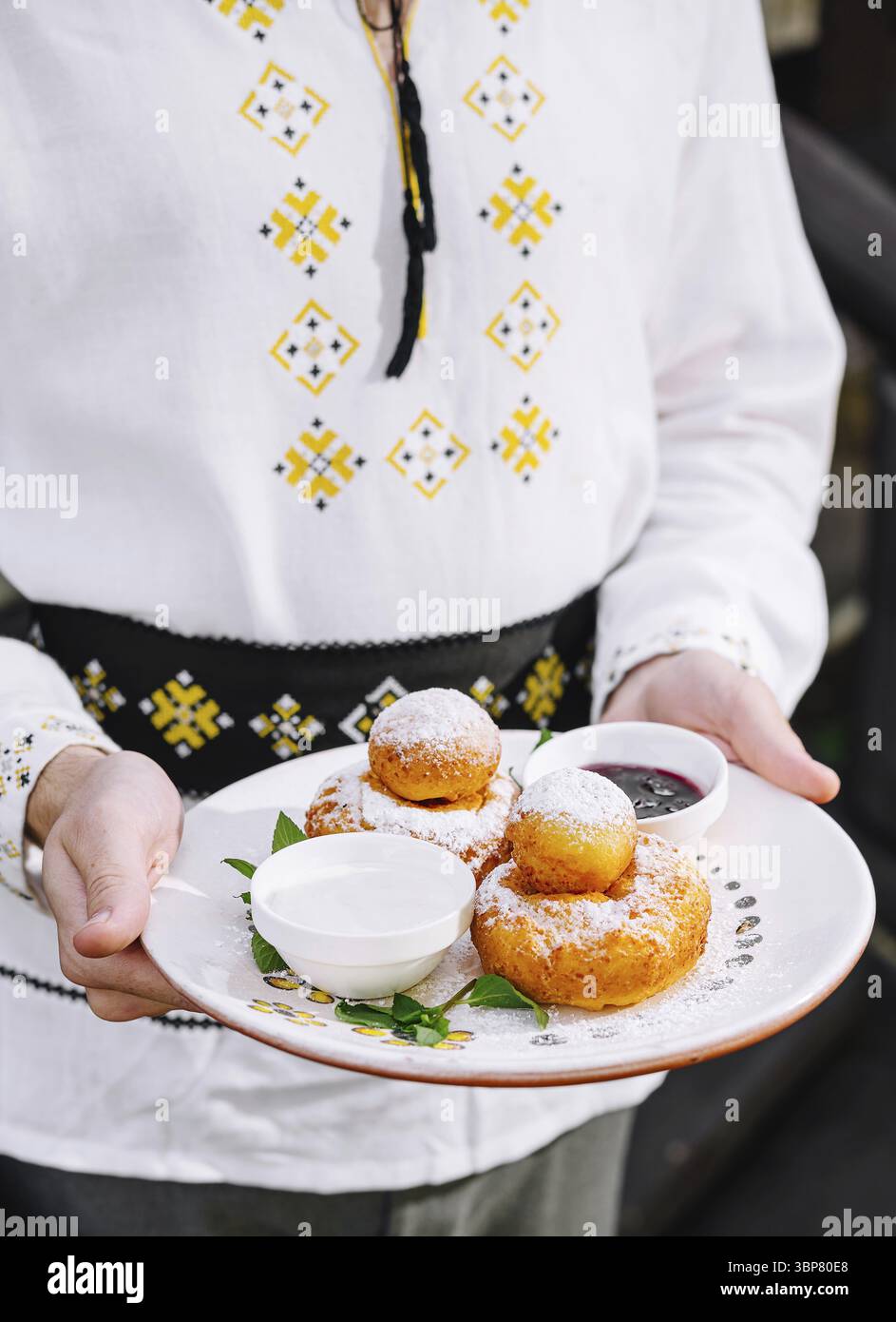 Food, Close-up of a person in ethnic costume serving local sweet ...