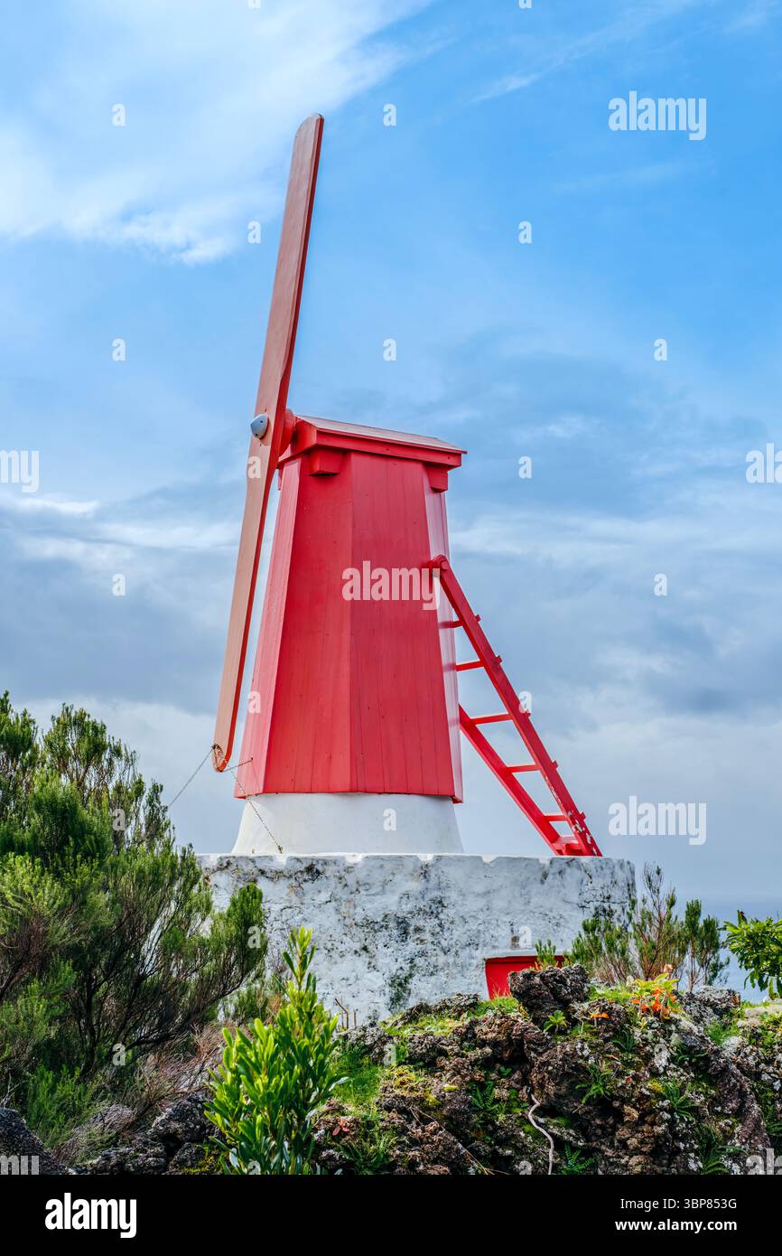 Vibrant Traditional Red Windmill Perched on a Grassy Hillside in ...