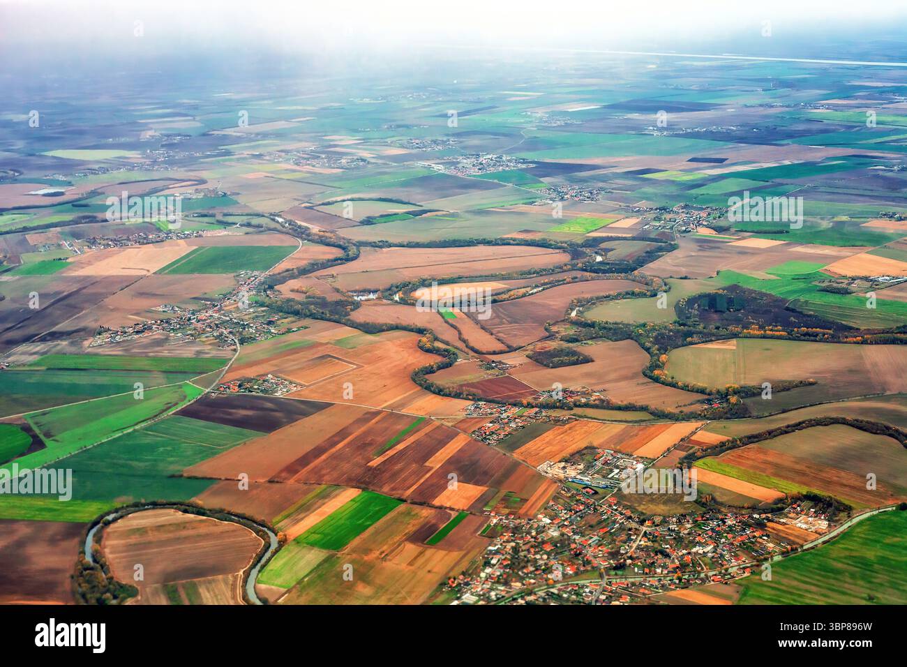 Aerial rural autumn fields and town of Slovakia, view from flying ...