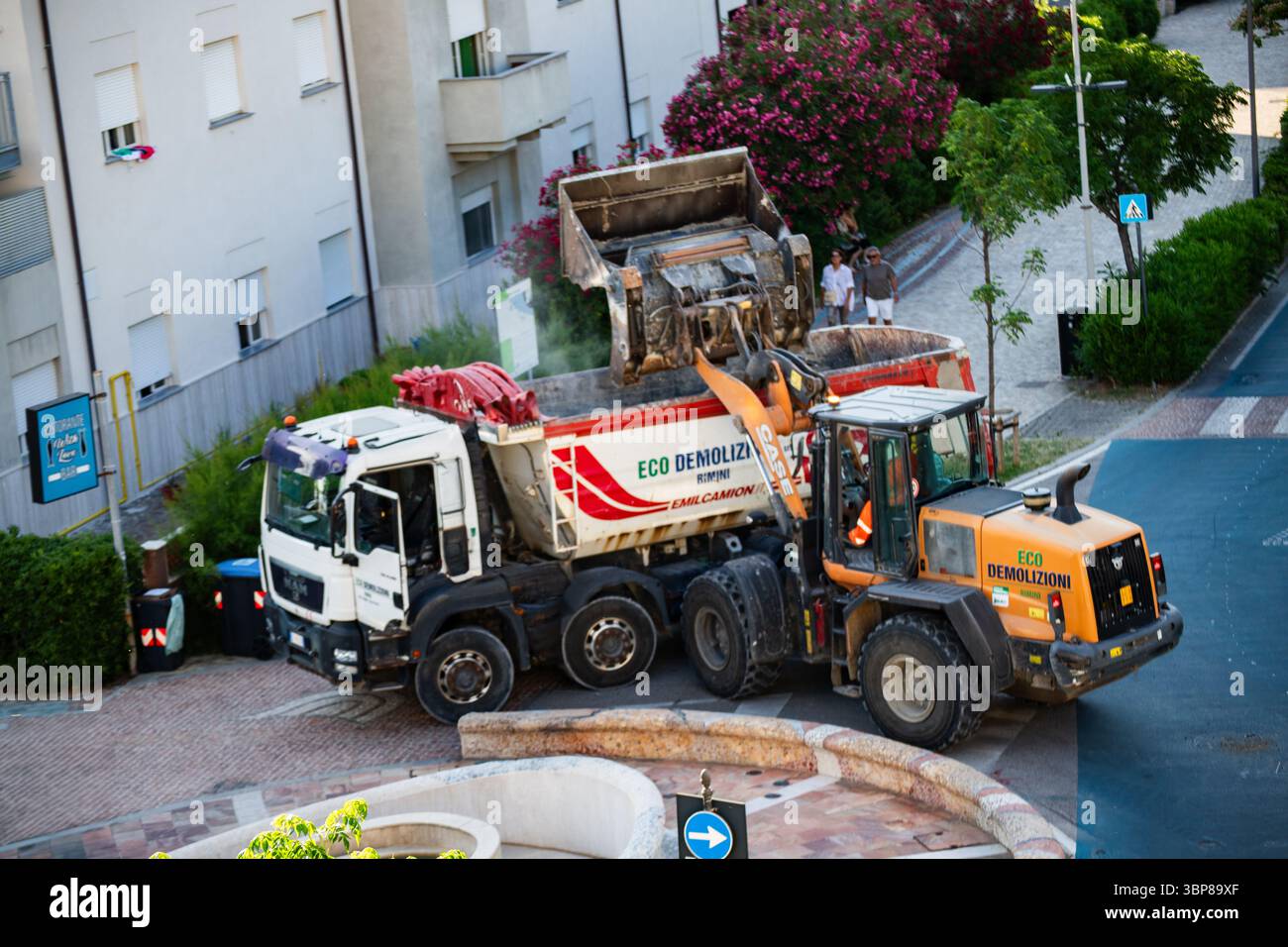 This industrial scene shows powerful vehicles collaborating for eco ...