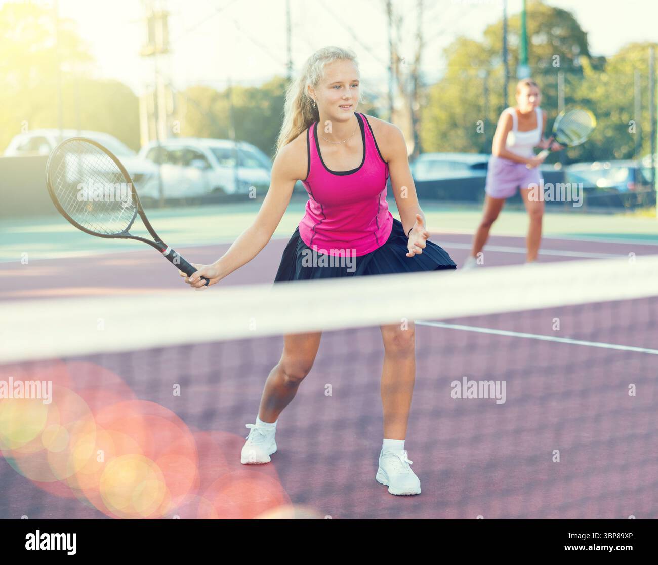 Female player playing tennis in tennis court outdoor behind net Stock ...