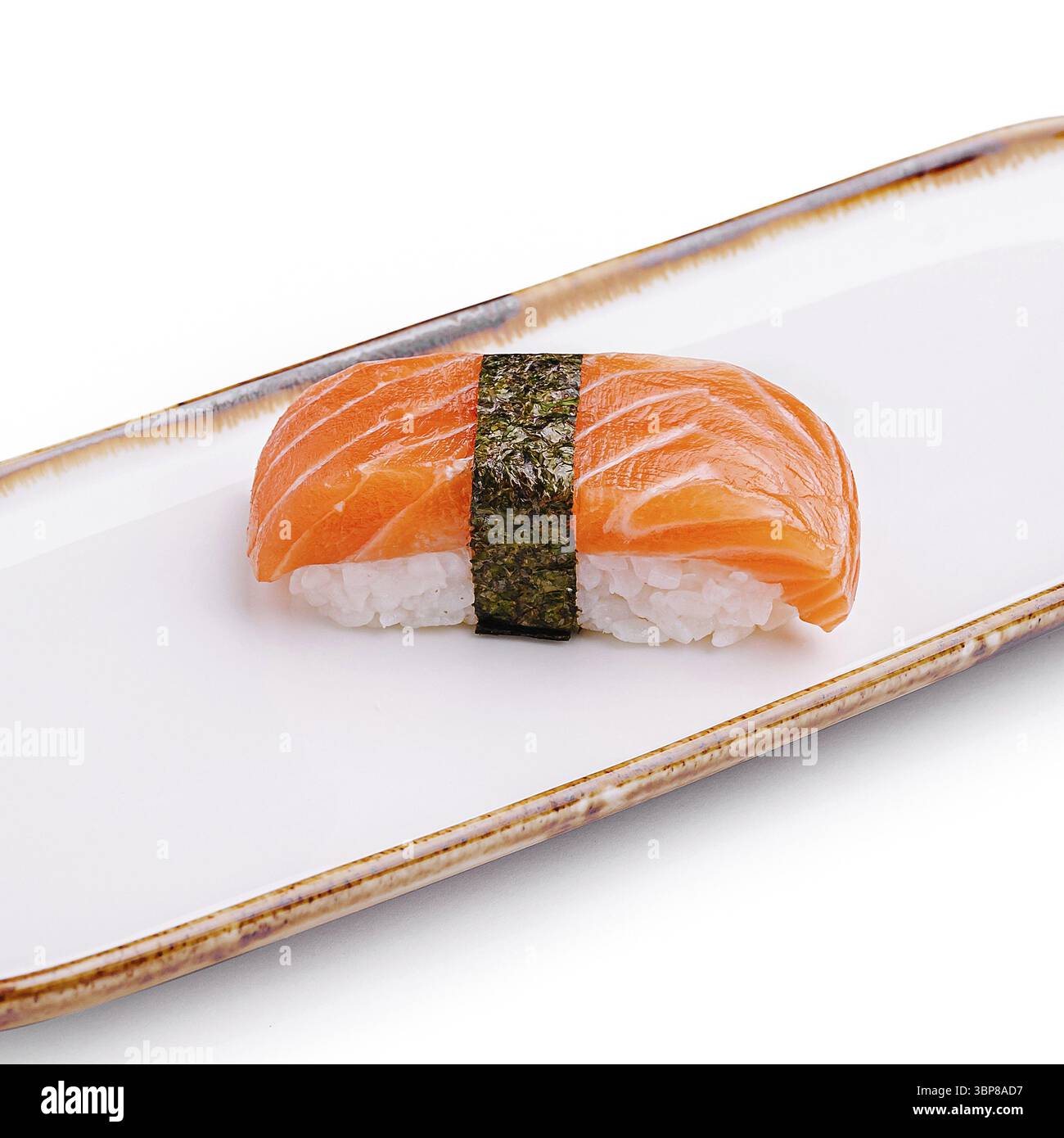 Food, A single piece of salmon nigiri sushi is placed on a decorative ...