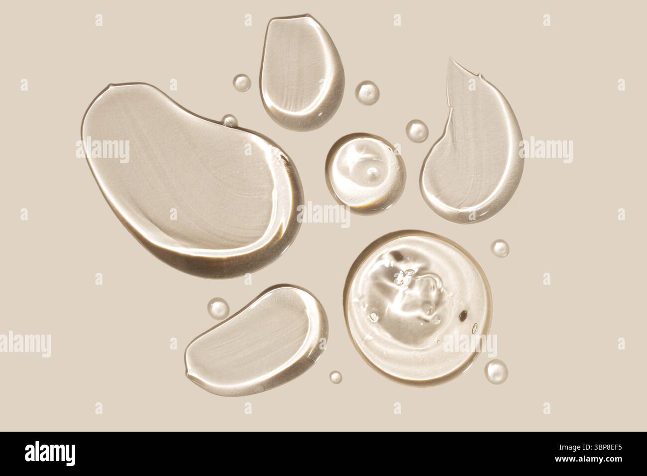 Pure transparent cosmetic gel drops and smears on beige background ...