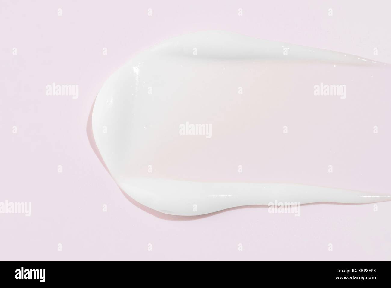 White cosmetic cream texture. lotion swatch on pink background. Beauty ...