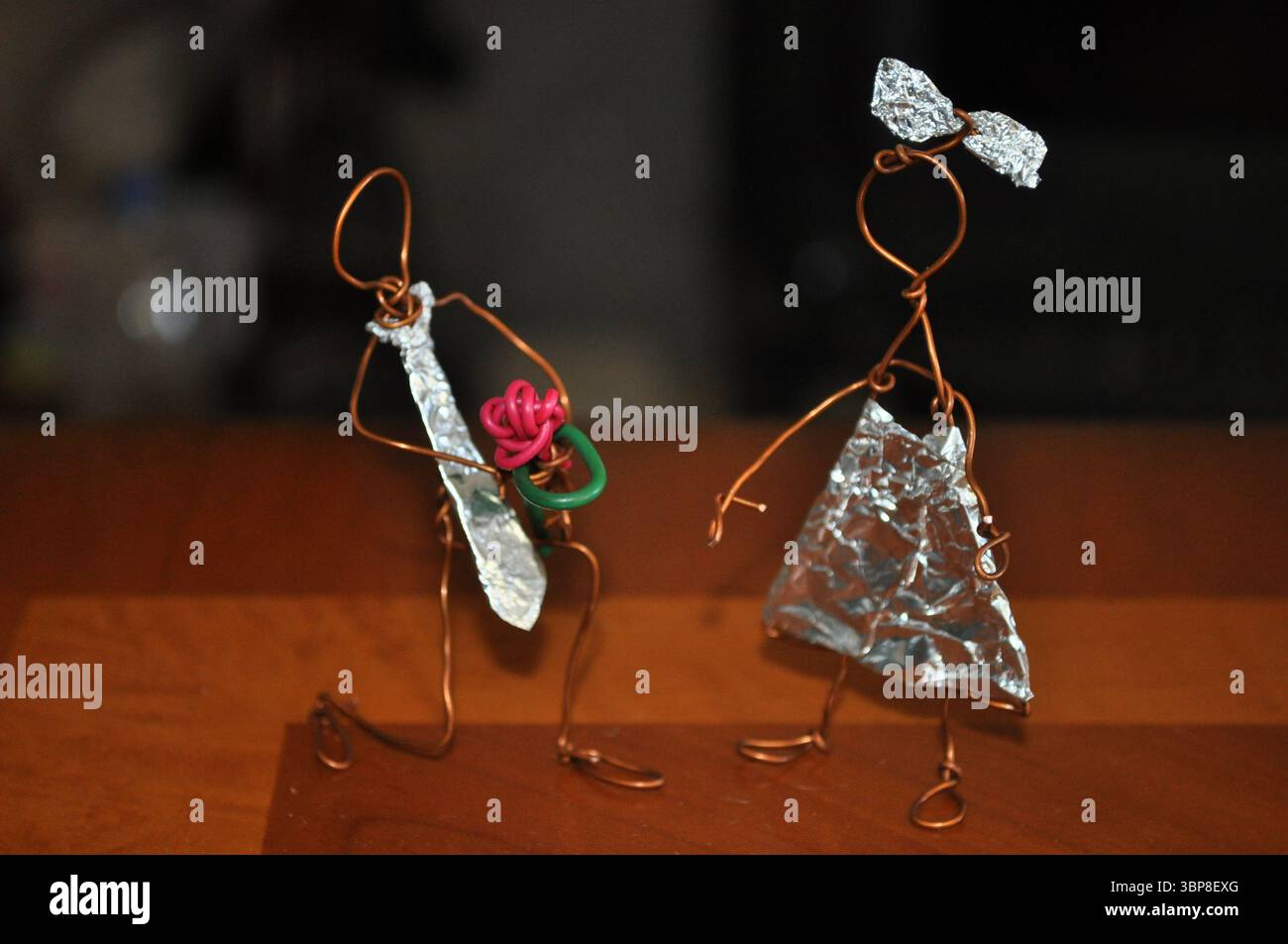 Handcrafted wire man giving flowers to wire woman. Kids crafts made ...