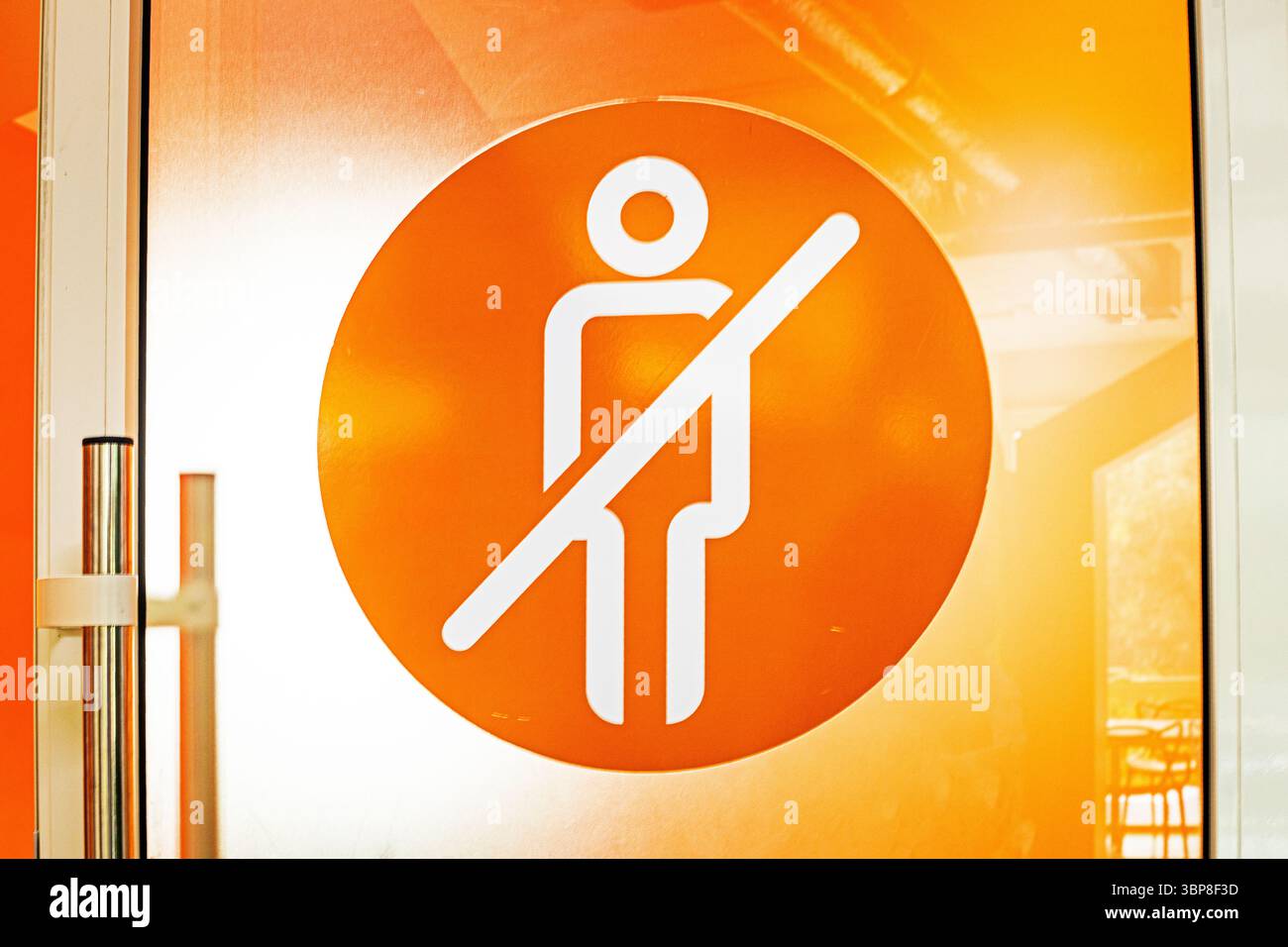 round orange schematic sign of a person prohibiting entry into these ...