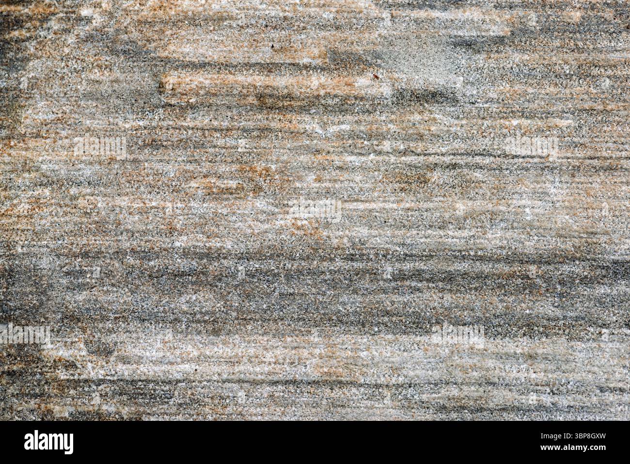 Natural stone surface displays a blend of earthy tones with textured ...