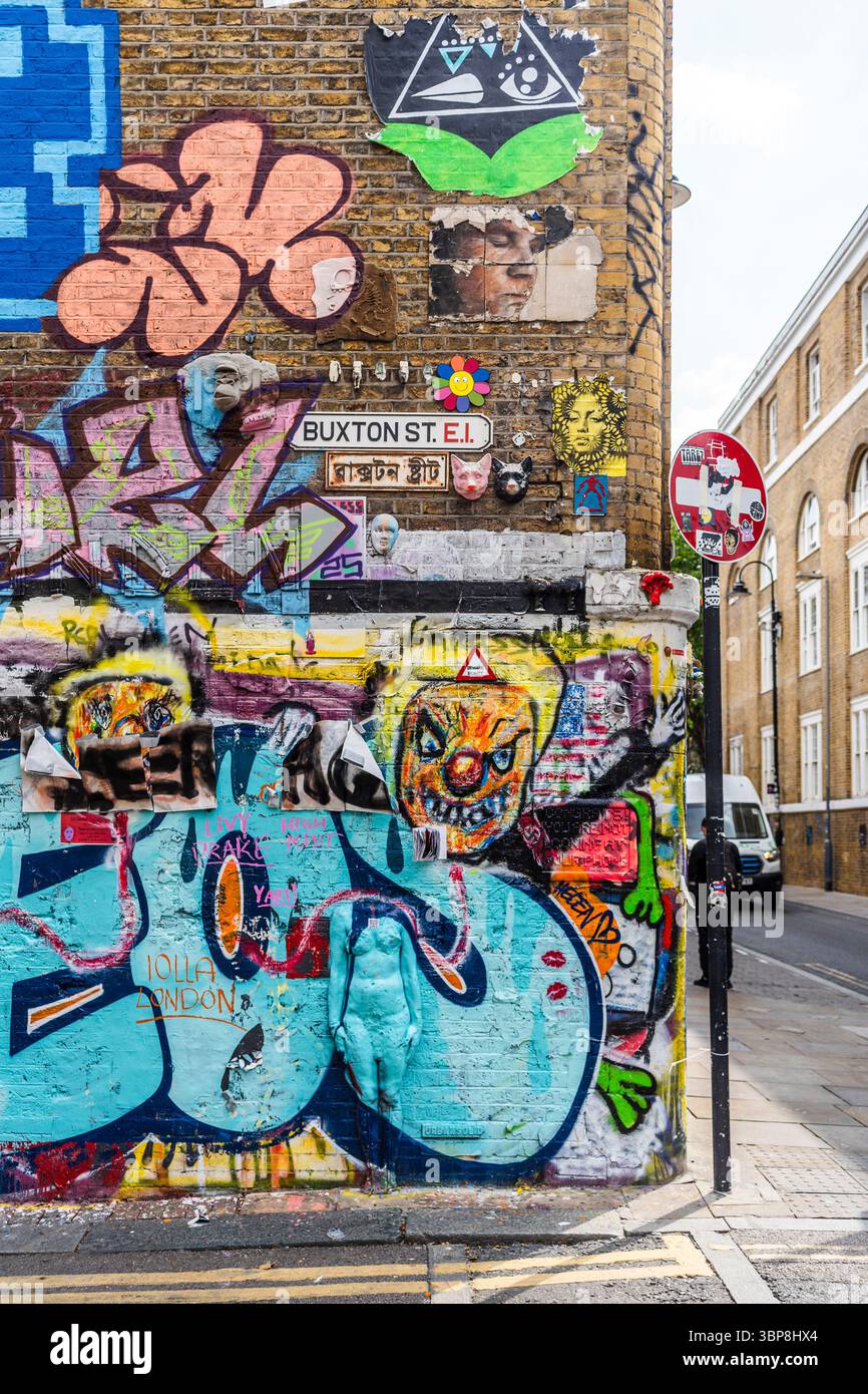 Colorful murals on a brick wall at the corner of Buxton Street and ...