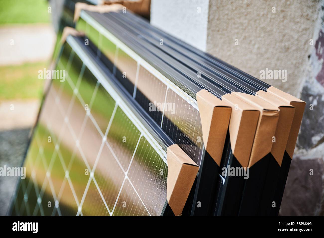 Close-up new solar panels with protective cardboard corners, ready for ...