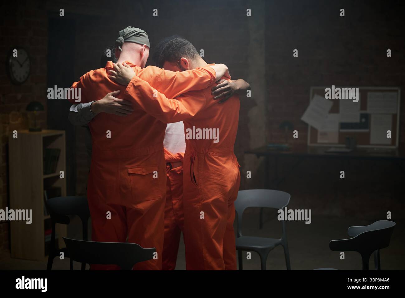 Group of young adult multiethnic men wearing prison uniforms standing ...