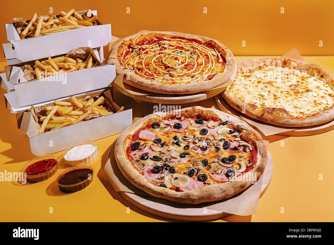 Food, Three different types of pizzas are arranged alongside stacks of ...