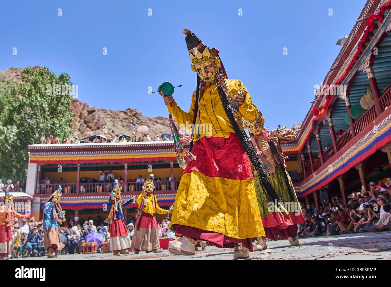 Buddhist monks in ceremonial costume perform a ritual dance during the ...