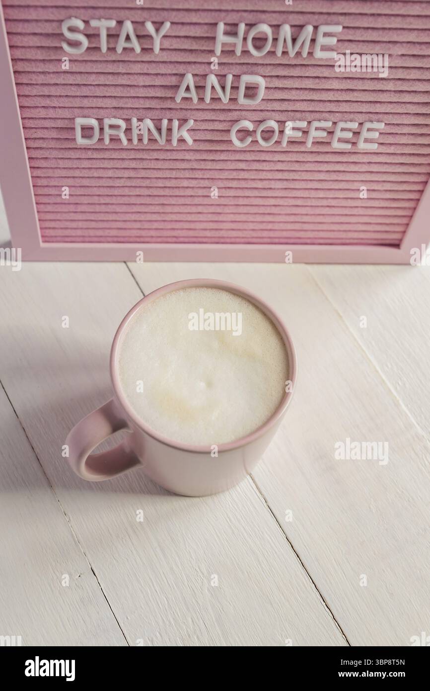 Pink Coffee cup and qoute Stay home and drink coffee. Self isolation ...