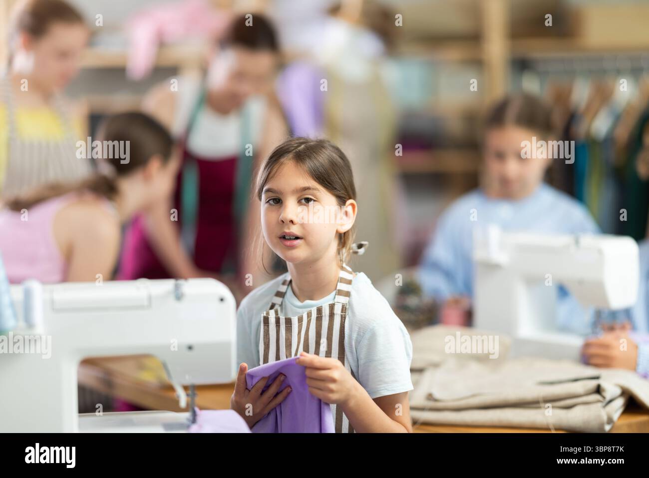 Girl child with cloth in hands Stock Photo - Alamy