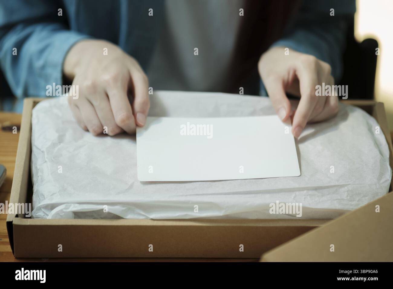 Person preparing a package with a blank card for a custom message ...