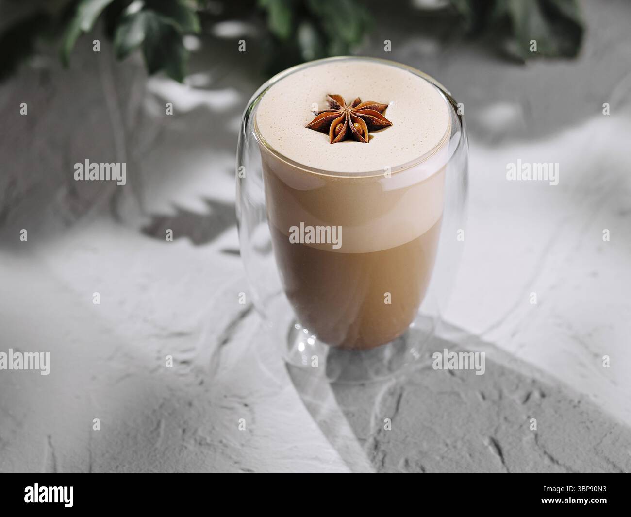 Food, Elegant glass of creamy spiced latte garnished with a star anise ...