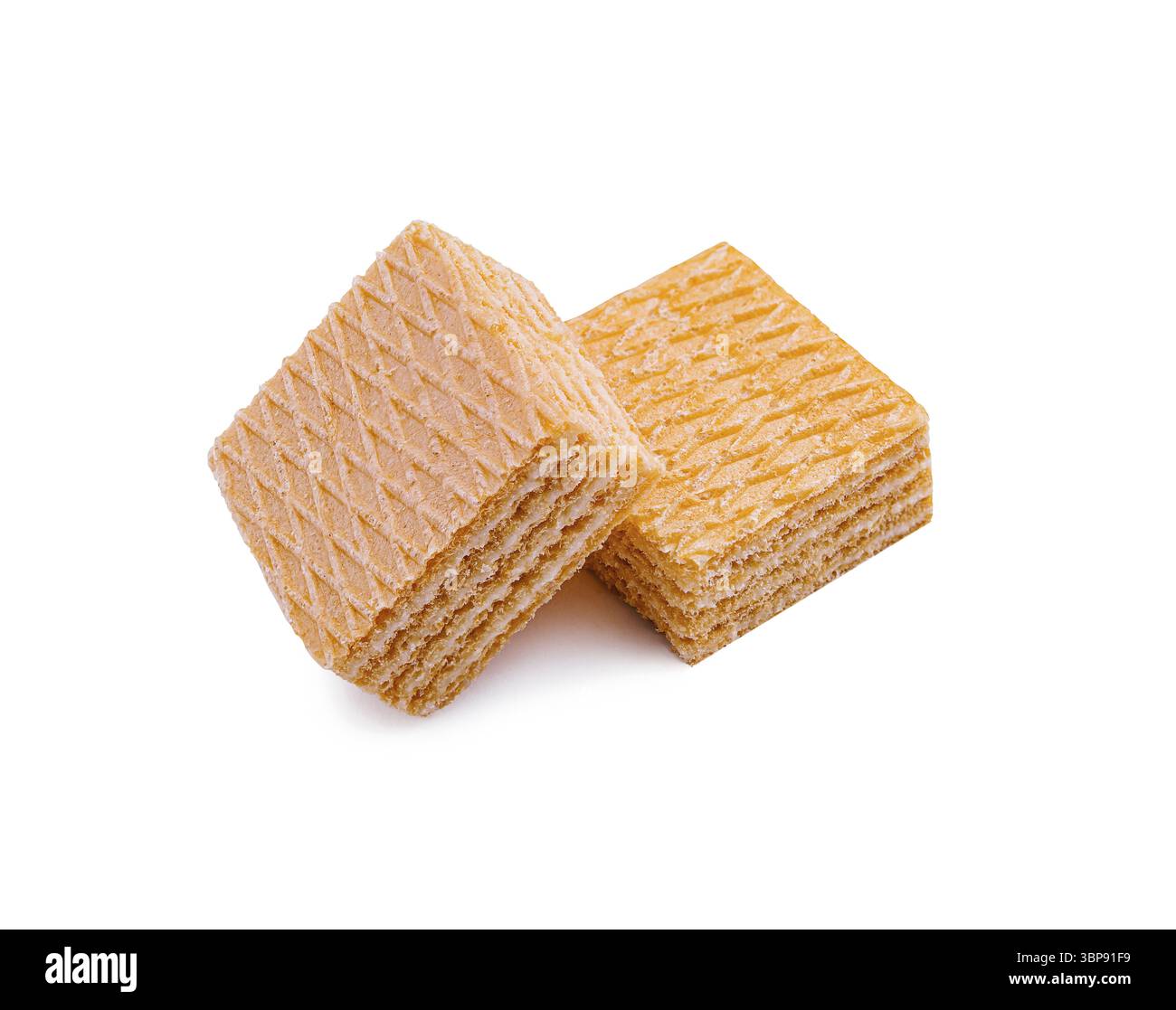 Food, Two golden wafers are neatly stacked on a clean white surface ...