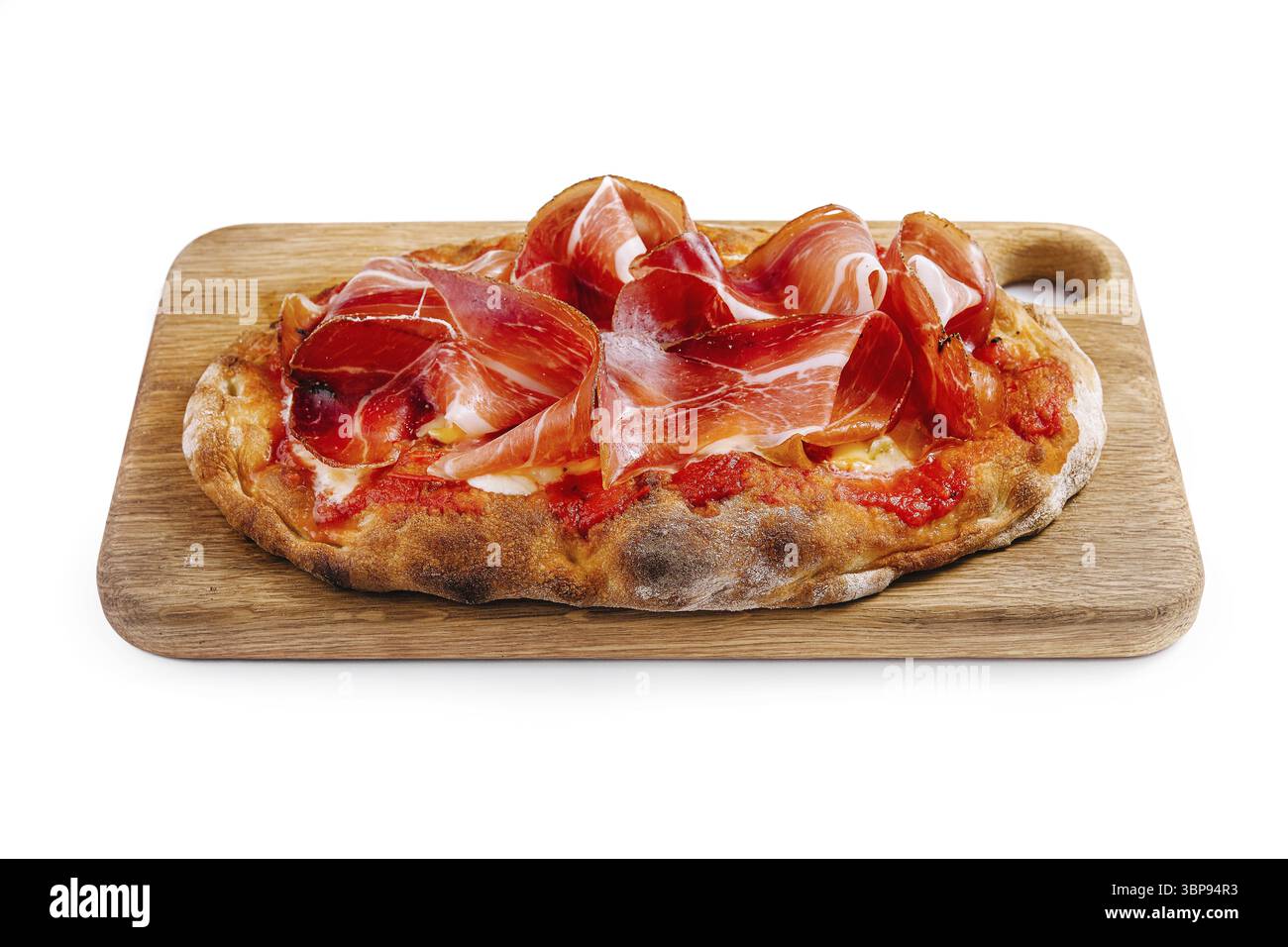 Food, Gourmet pizza with cured ham and tomato on a cutting board ...