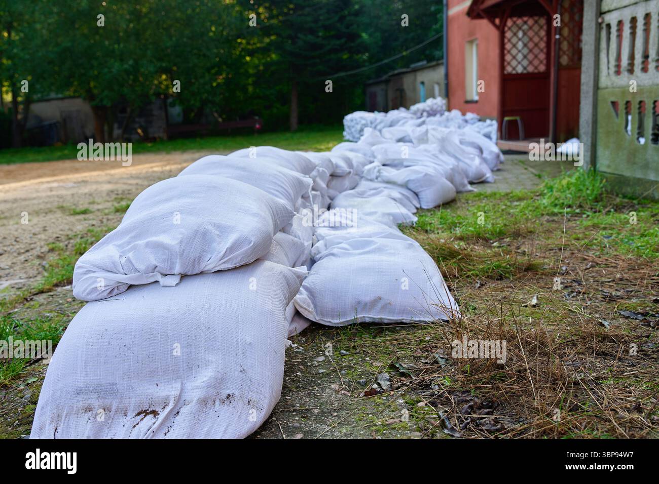 Sandbags stacked outside building to protect against flooding ...