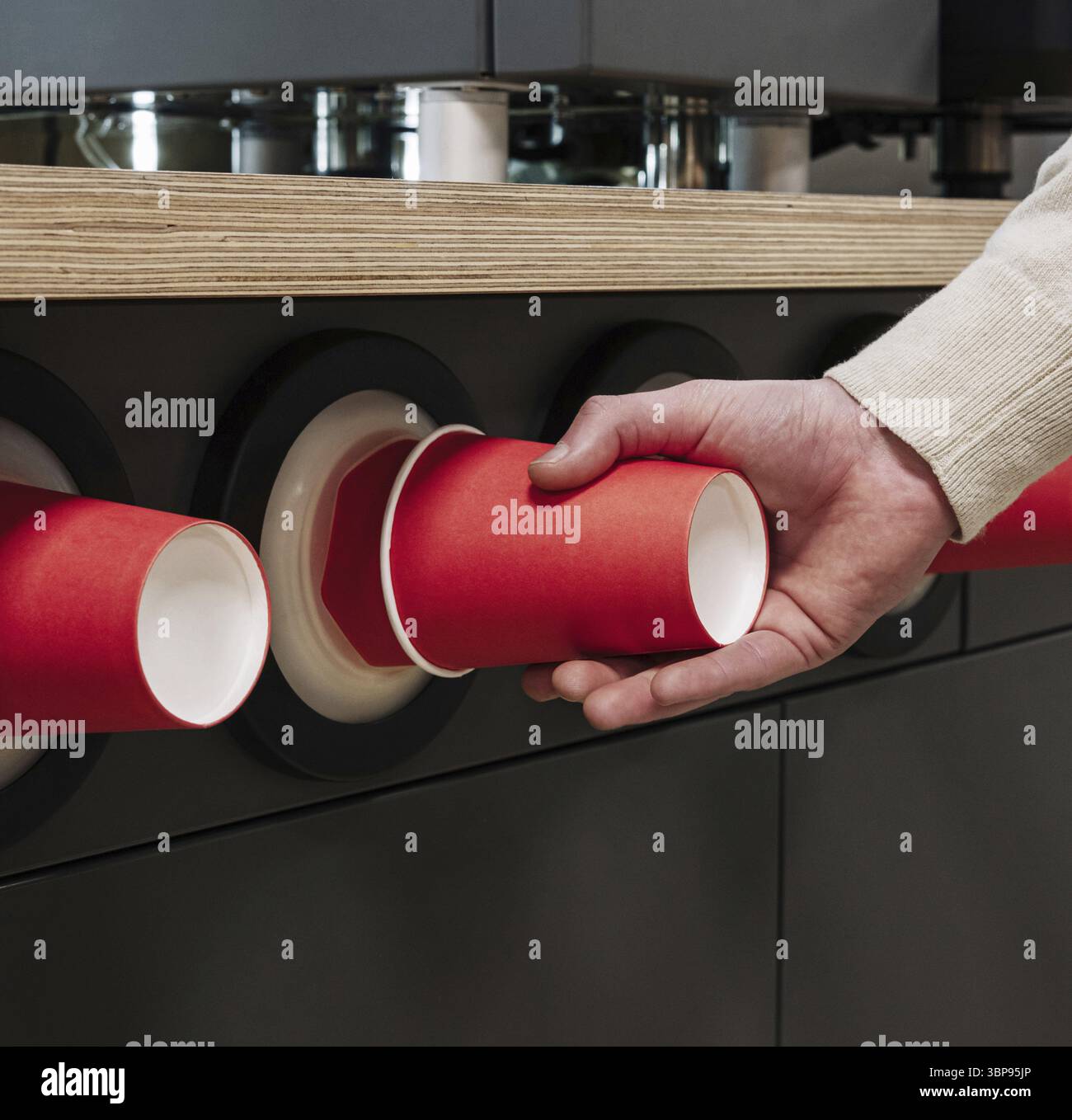 Food, Close-up of a hand pulling a red paper cup from a modern cup ...