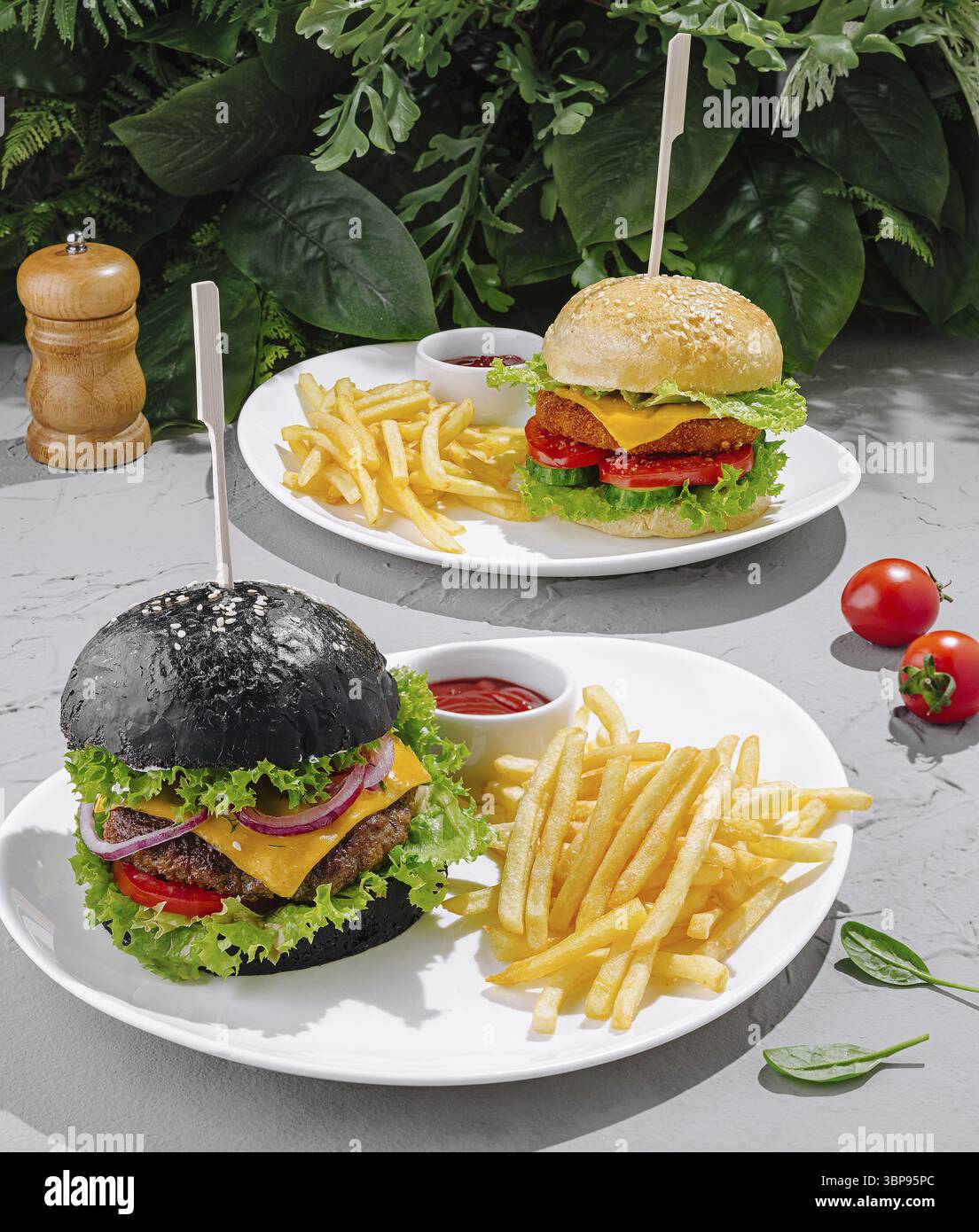 Food, Two gourmet burgers sit on plates with crispy fries alongside ...