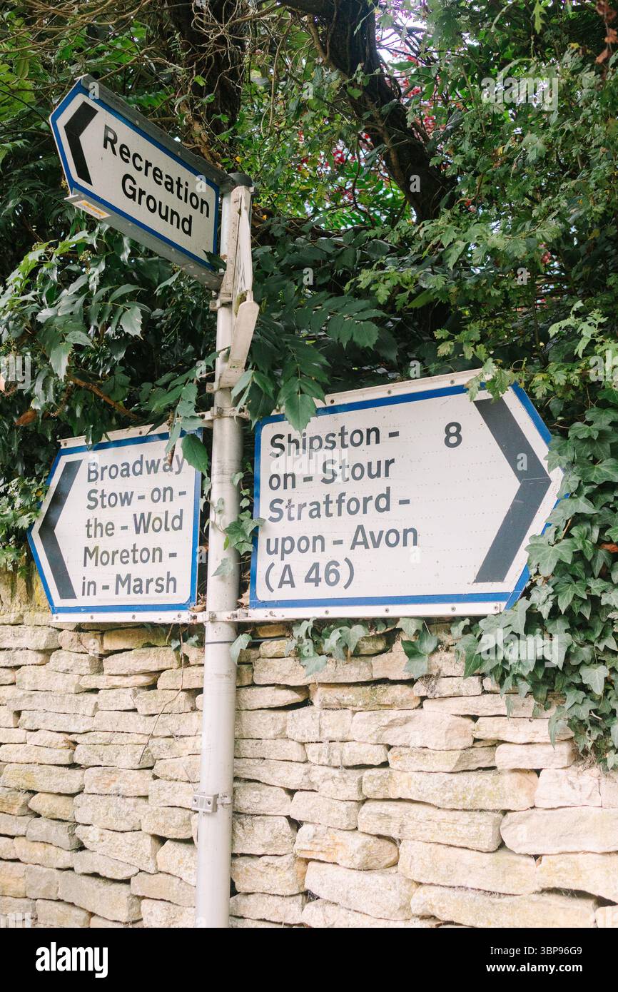 British Road Signs in Cotswolds Village with Stone Wall Stock Photo - Alamy