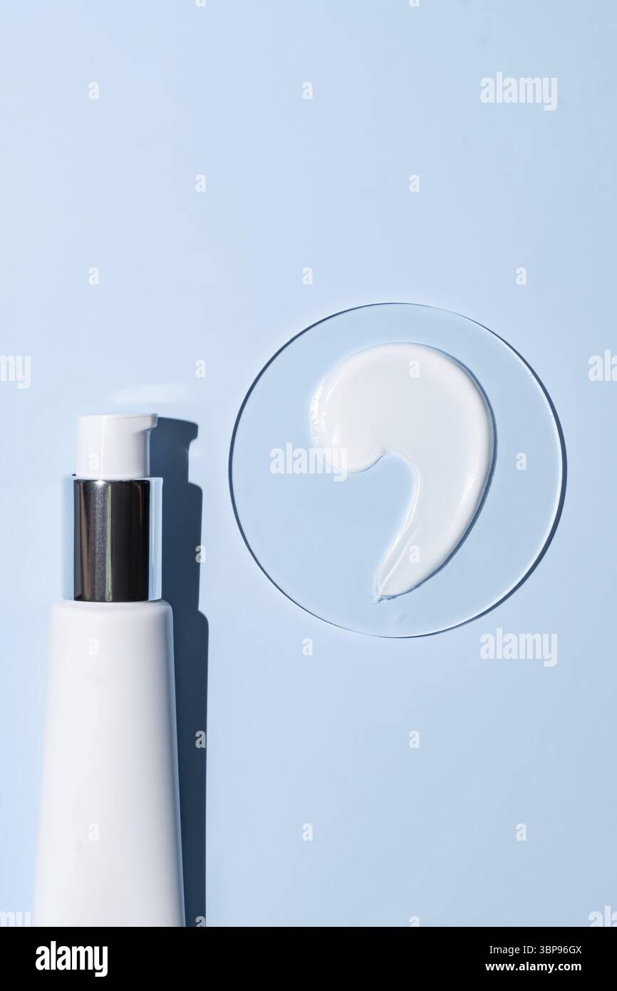 White pomp tube of face or hand cream and sample texture in petri dish ...
