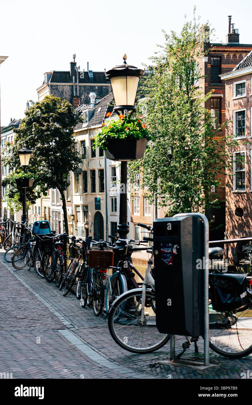 Bicycles line the picturesque canal in Utrecht, showcasing the ...