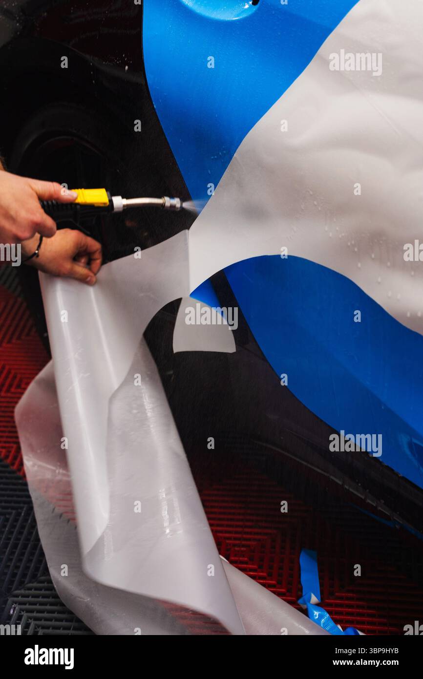 Paint Protection Film PPF Application Process. Detailer removes the ...