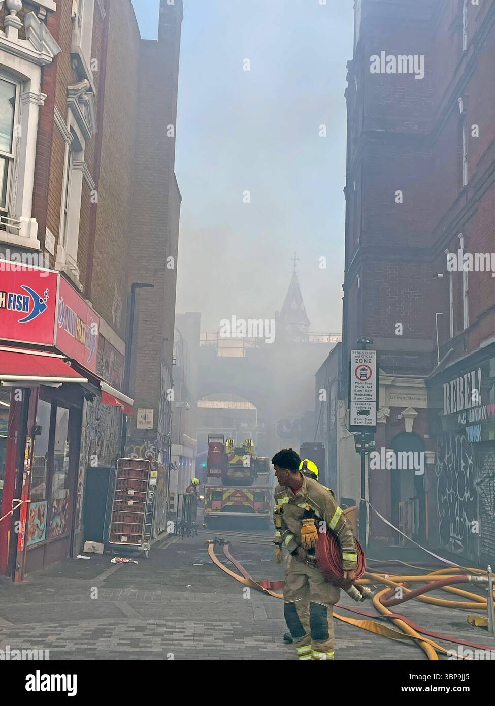 Firefighters at the scene on Electric Avenue in Brixton, London ...