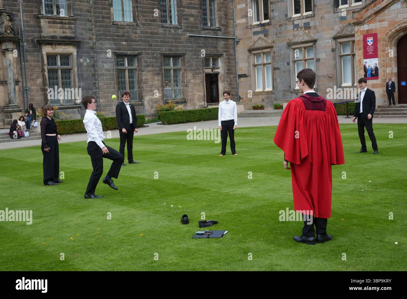 Members of the St Salvator's Chapel Choir relax by playing a ball game ...