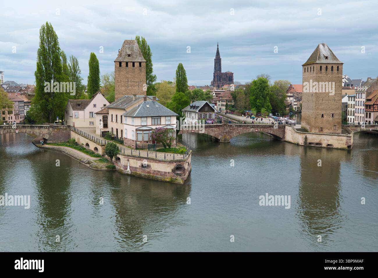 Historic stone towers and bridges over a calm river in a European town ...