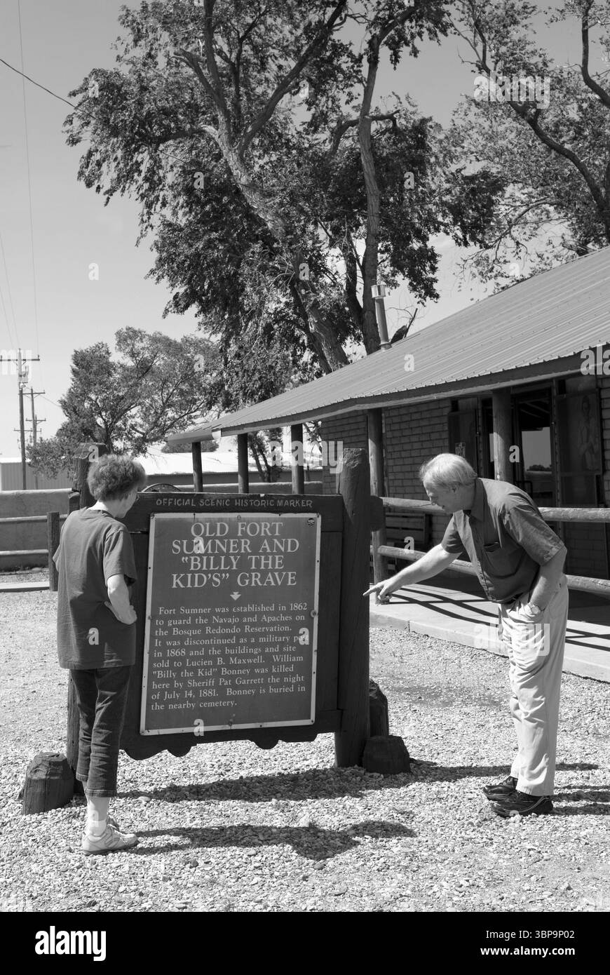 Caucasian female watches male pointing to info board at Old Fort Sumner ...