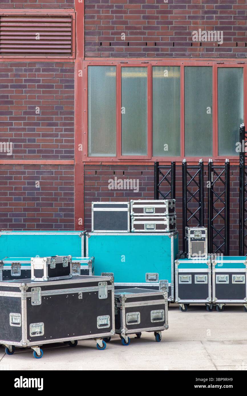 Group of black and blue flight cases in front of an old factory ...