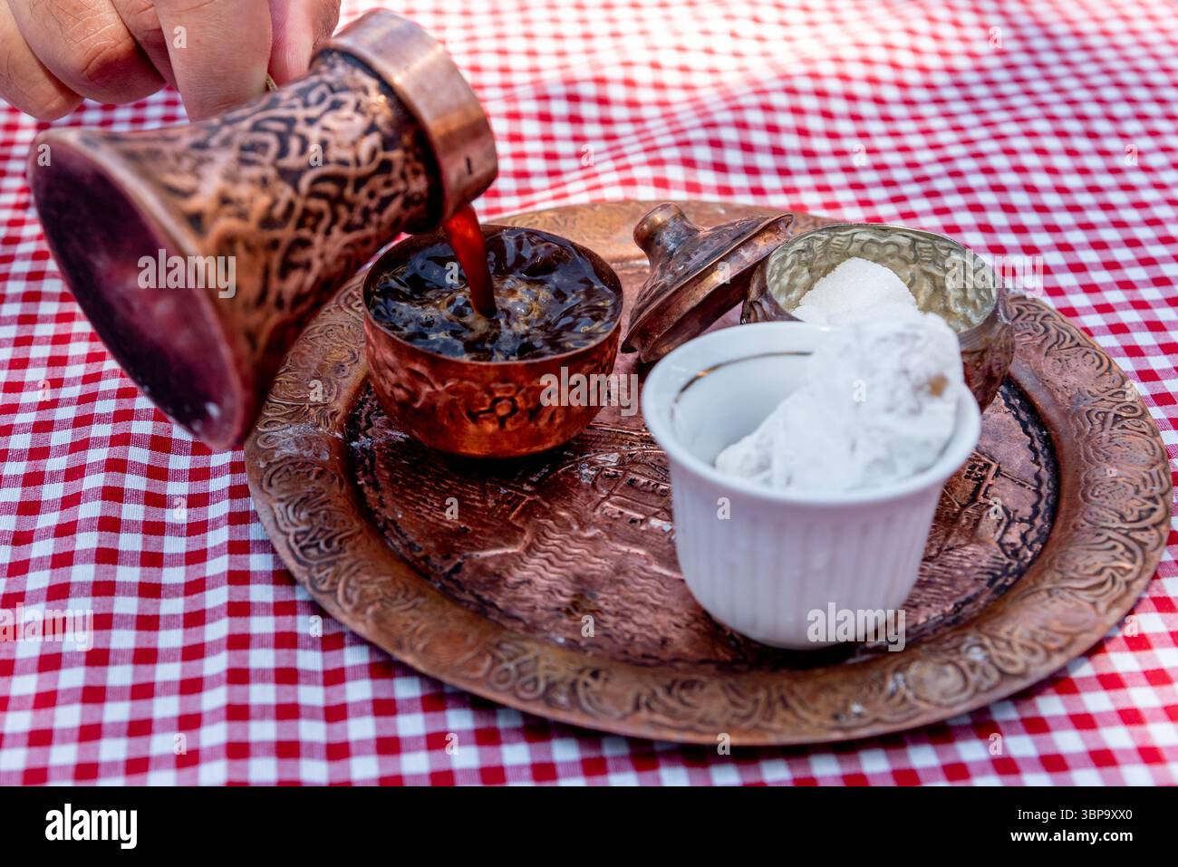 Traditional Turkish coffee brewed in cezve on the sand is served in ...